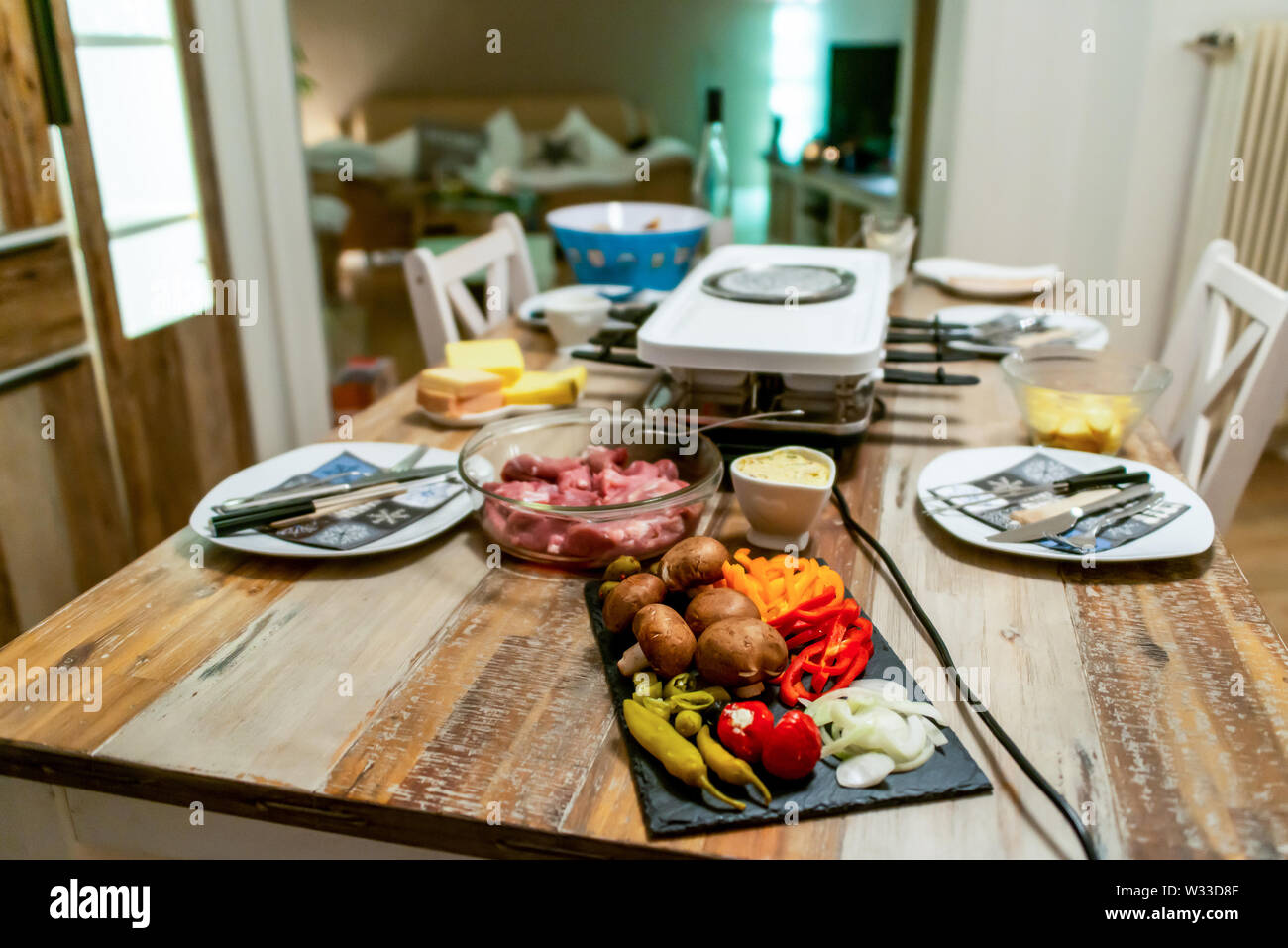 Swiss or Dutch raclette table filled with ingredients for a celebratory ...