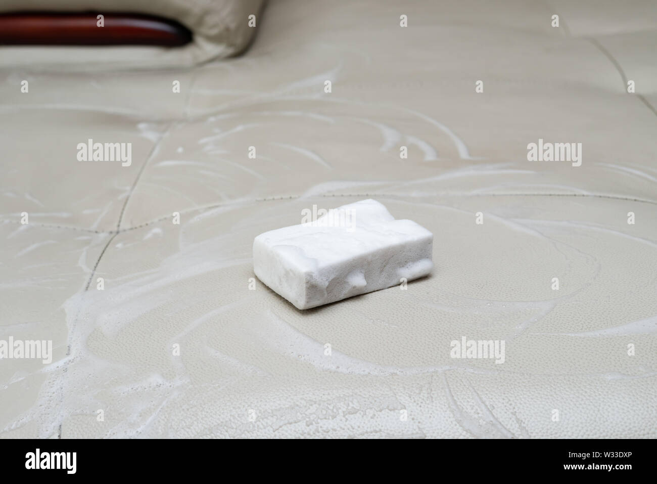 leather sofa with a soapy sponge Stock Photo - Alamy