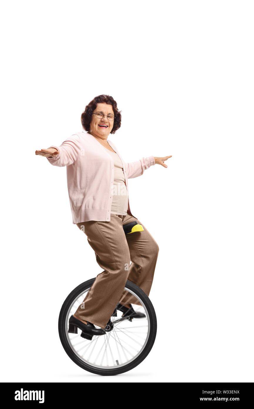 Full length shot of a senior woman riding a unicycle and smiling ...