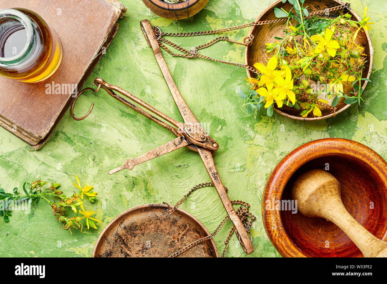 Flowering medicinal hypericum on medical scales.Medicinal herbs ...