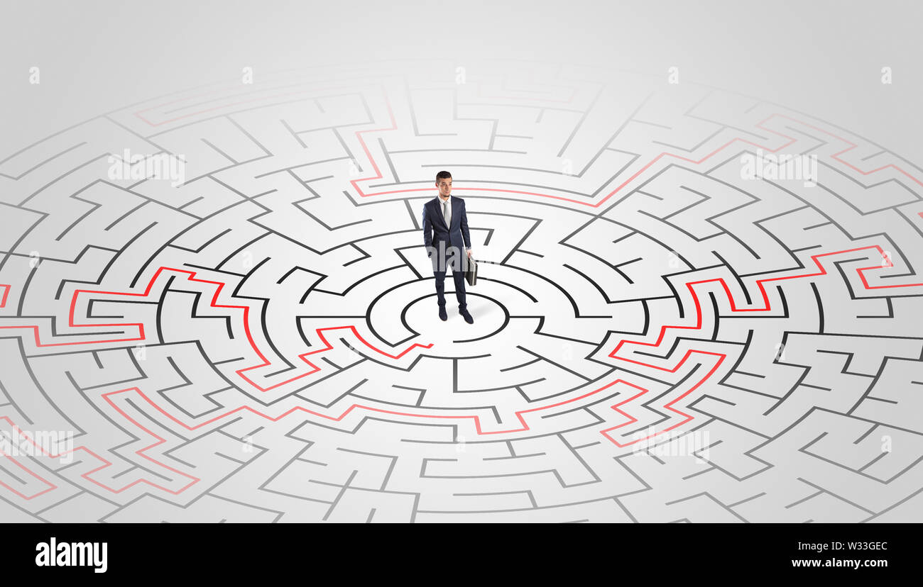 Young entrepreneur standing in a middle of a labyrinth with the ...