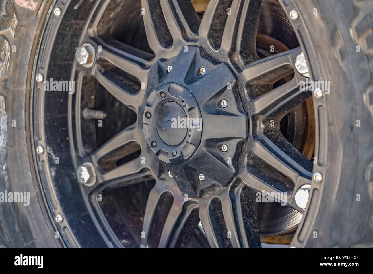 Close up view of the black rubber wheel of a vehicle. The wheel has a ...
