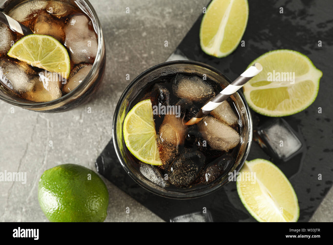 Glasses with cold cola and citrus on grey table, top view Stock Photo ...