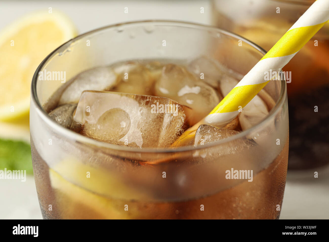 Glasses with cold cola and citrus on white cement background, closeup ...