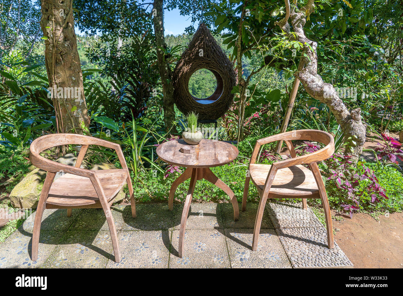 Wooden table and chairs in empty tropical cafe next to rice terraces in ...