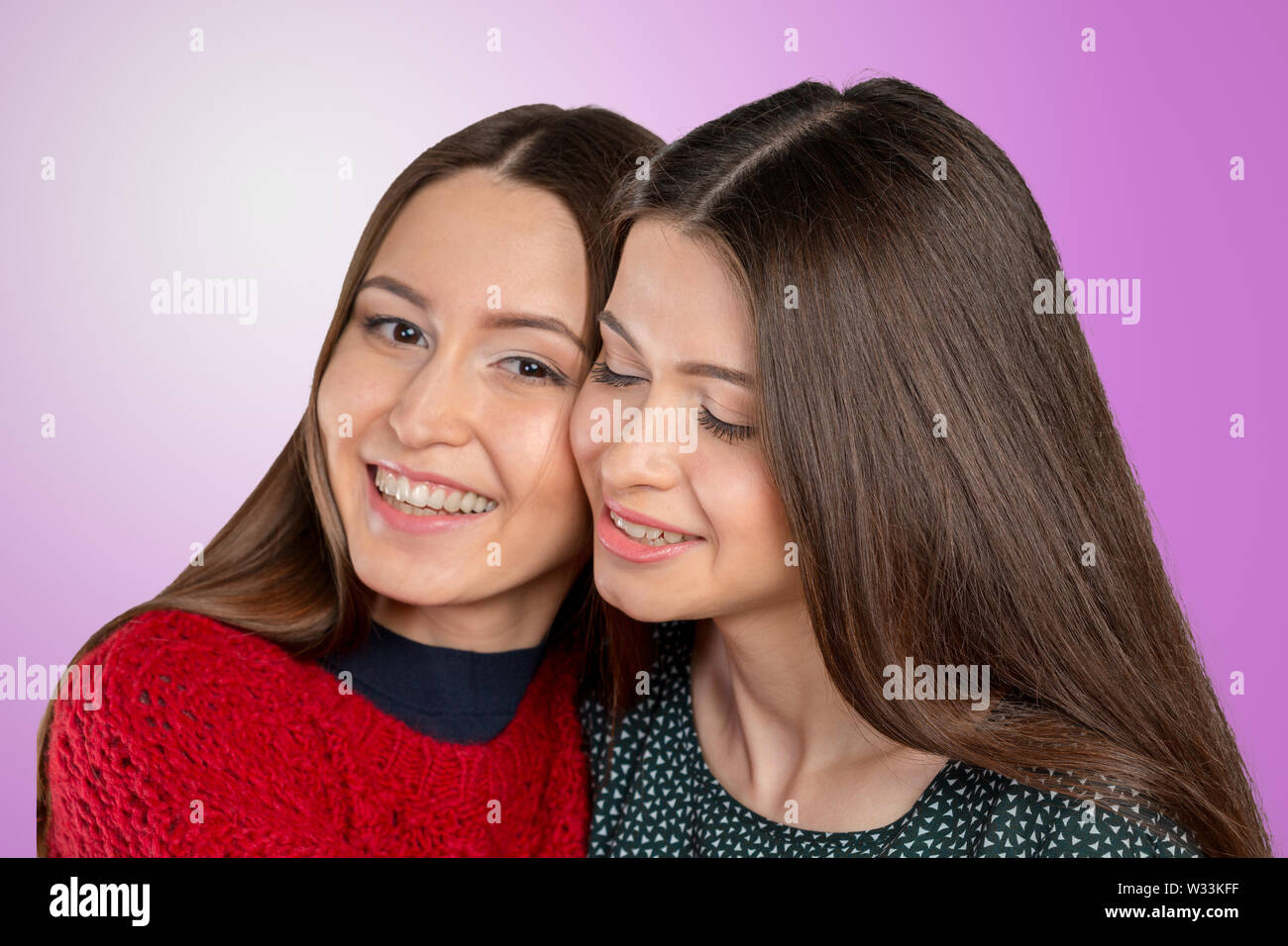 Two beautiful sisters hugging each other and smiling Stock Photo - Alamy