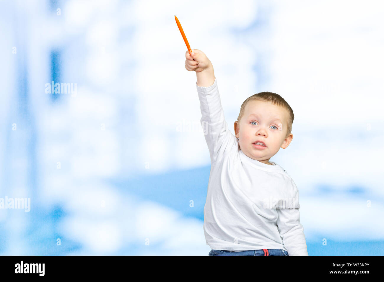 Cheerful little boy pointing up Stock Photo - Alamy
