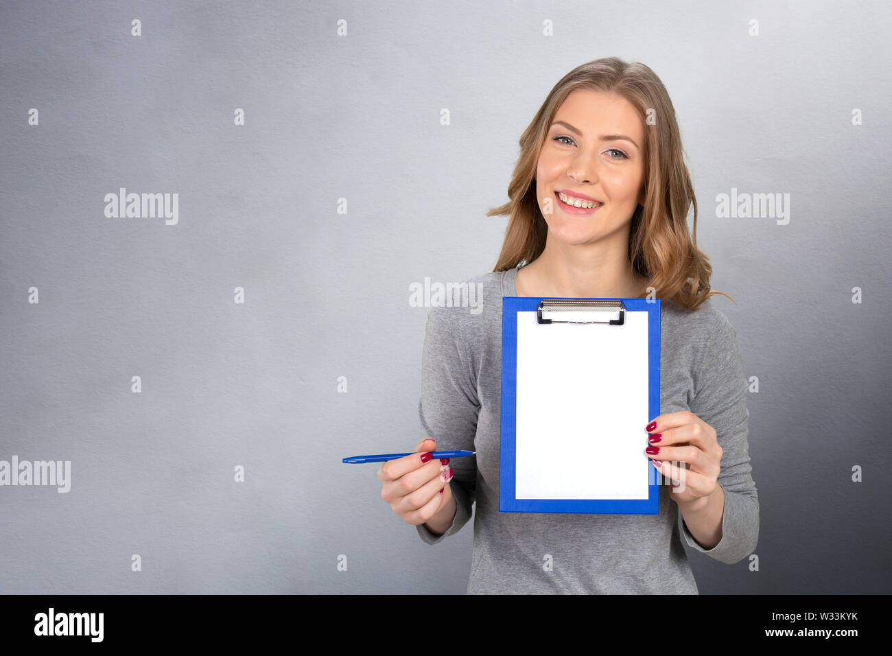 Young Woman With Pen and Note Pad Stock Photo - Alamy