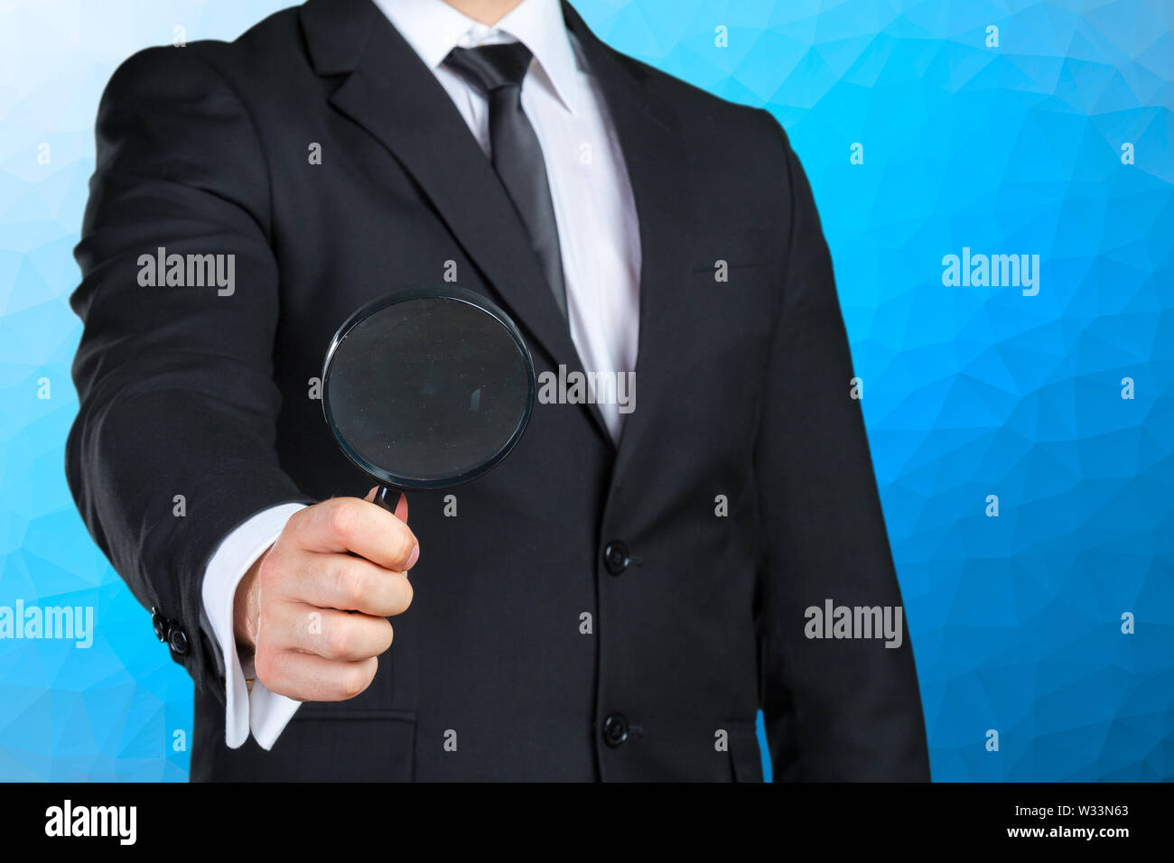 business man holding magnifying glass concept Stock Photo - Alamy