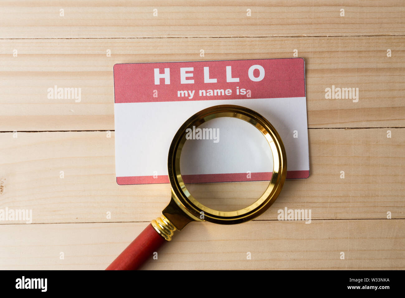Blank name tag with magnifier glass Stock Photo - Alamy