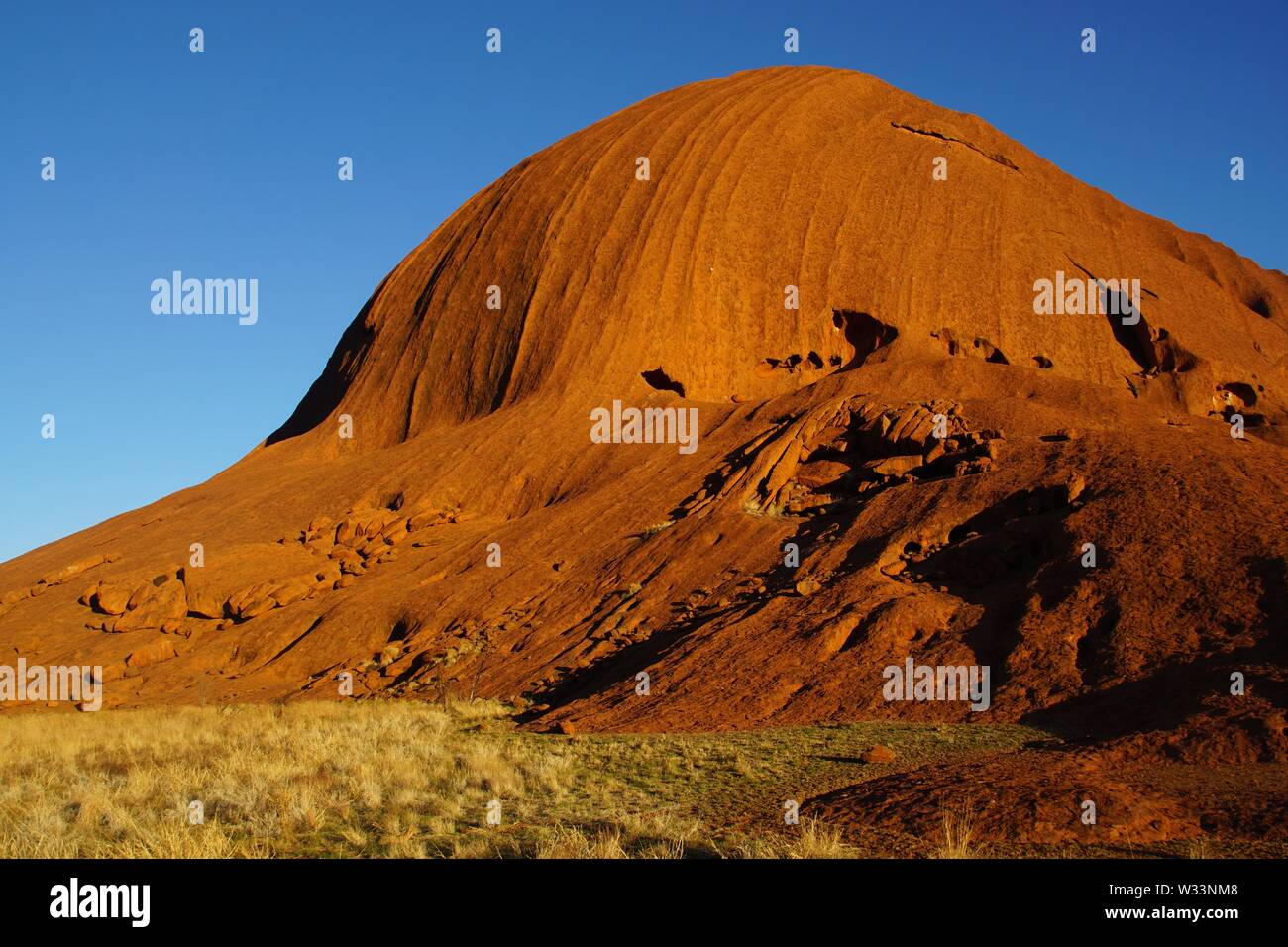Early Morning Sun illuminating an Uluru Rock Formation Stock Photo - Alamy
