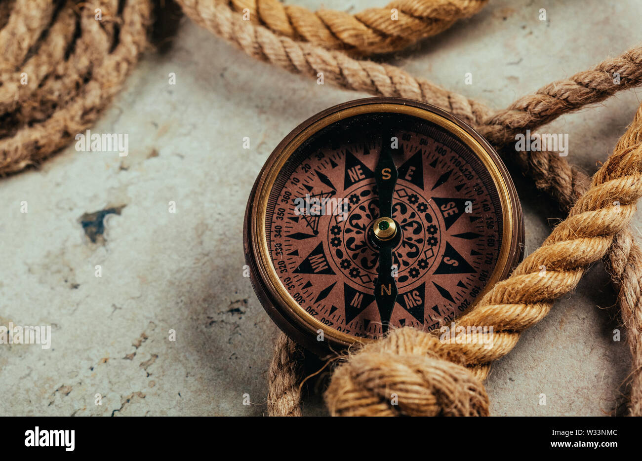 Compass on a gray gradient background Stock Photo - Alamy