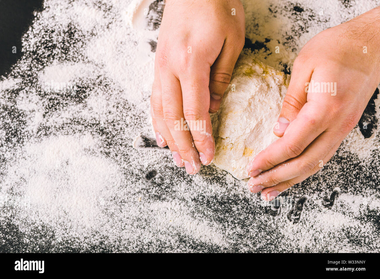 Hands kneading a dough Stock Photo - Alamy