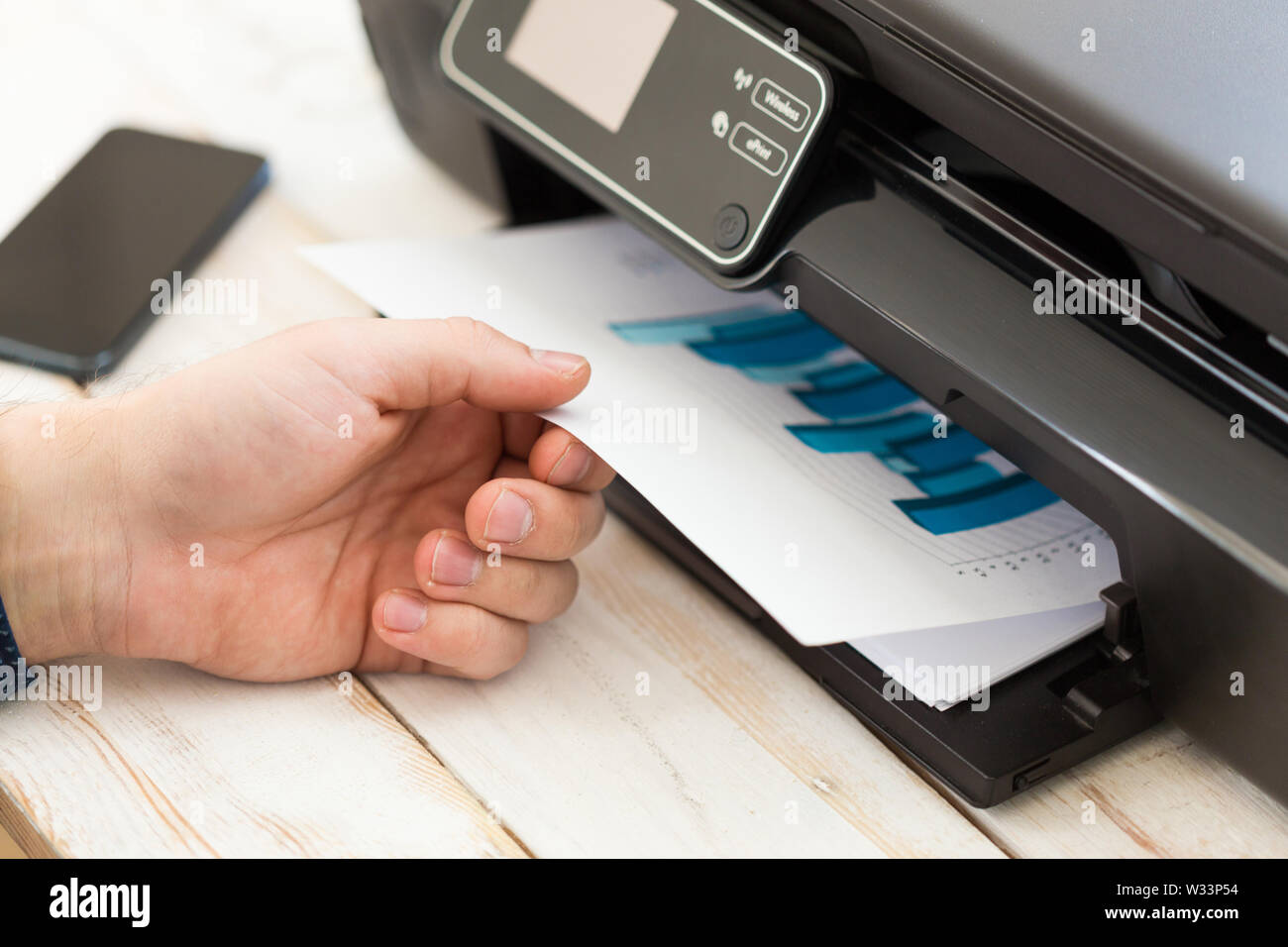 Man's hand making copies. Working with printer Stock Photo - Alamy