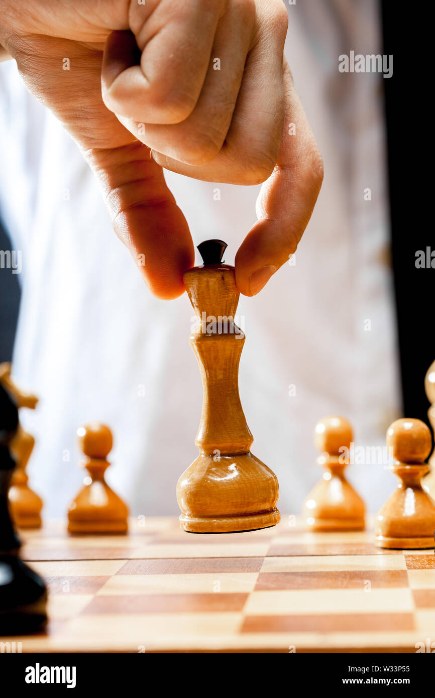 Hand of businessman playing chess Stock Photo - Alamy