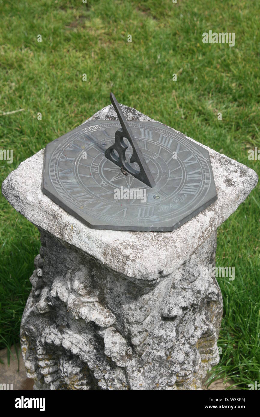 Garden sun dial on a stone column Stock Photo - Alamy