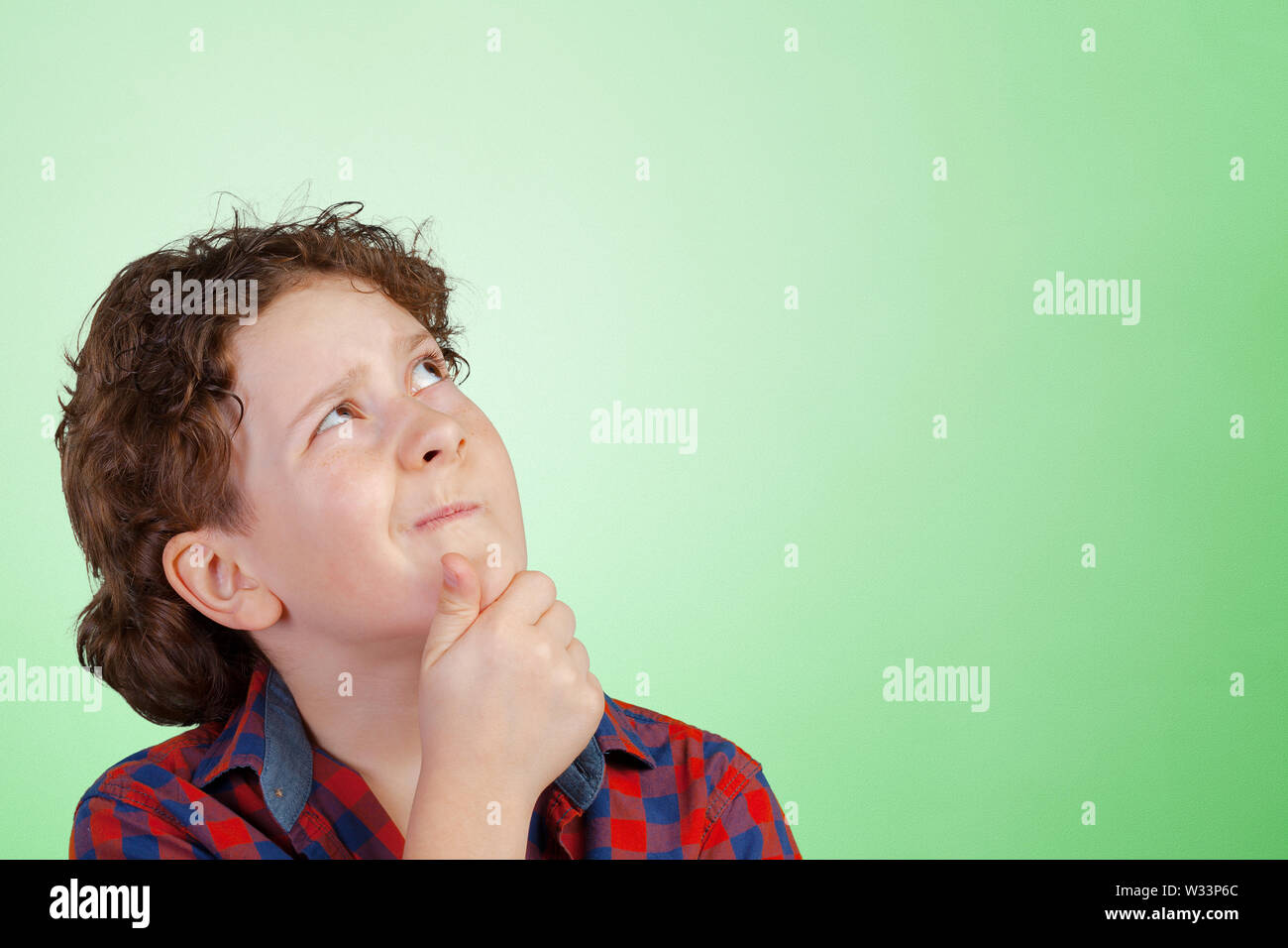 cute young boy thinking Stock Photo - Alamy