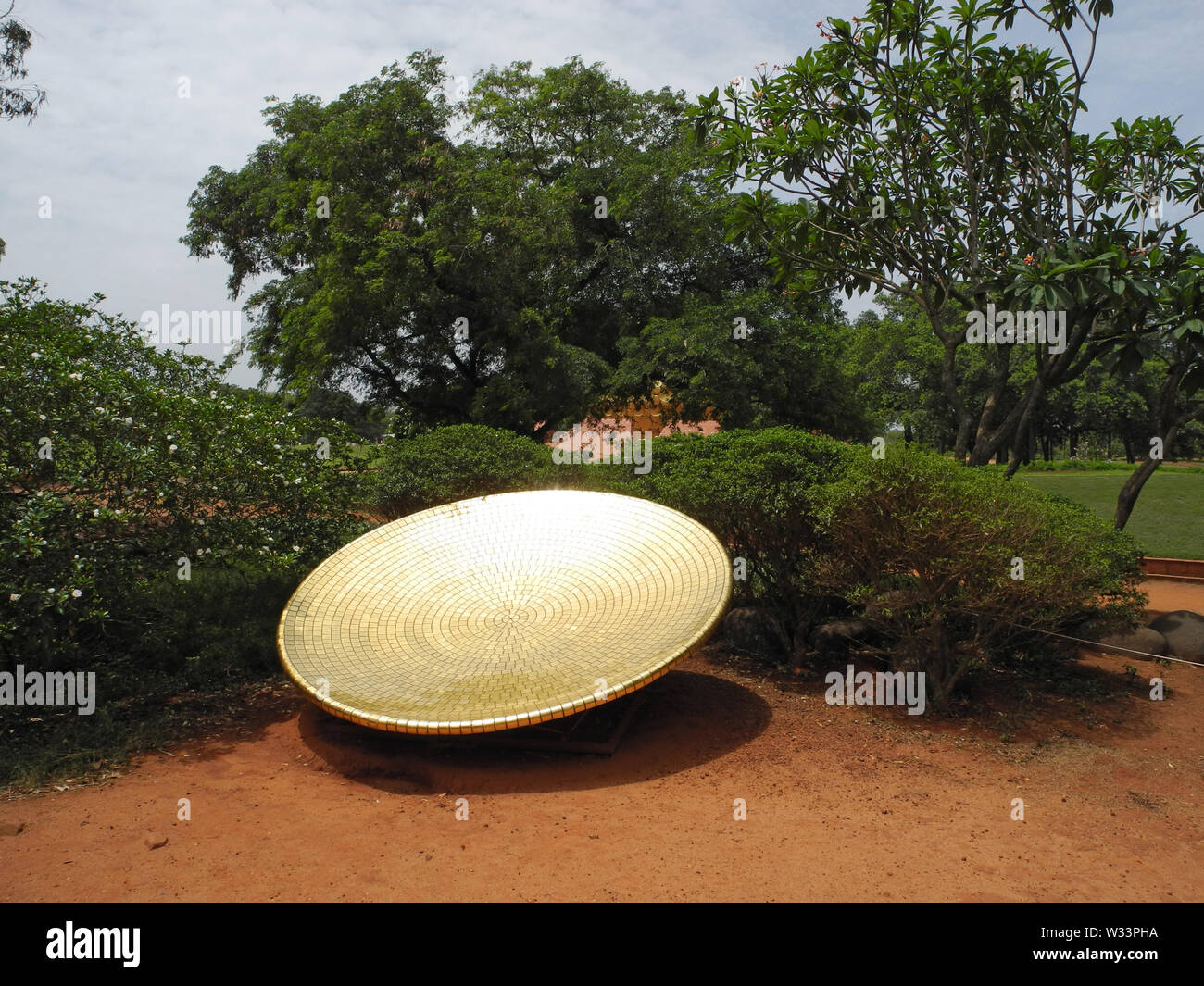 Yellow plate on a background of green trees, Tamil Nadu, Auroville ...