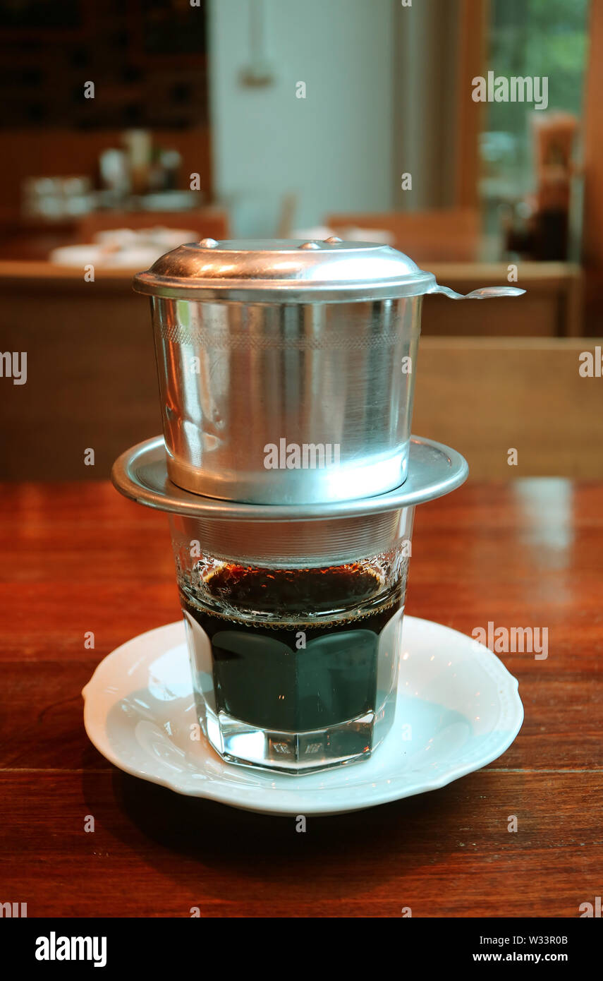 Vertical Image of Vietnamese Drip Coffee Slowly trickling Into ...