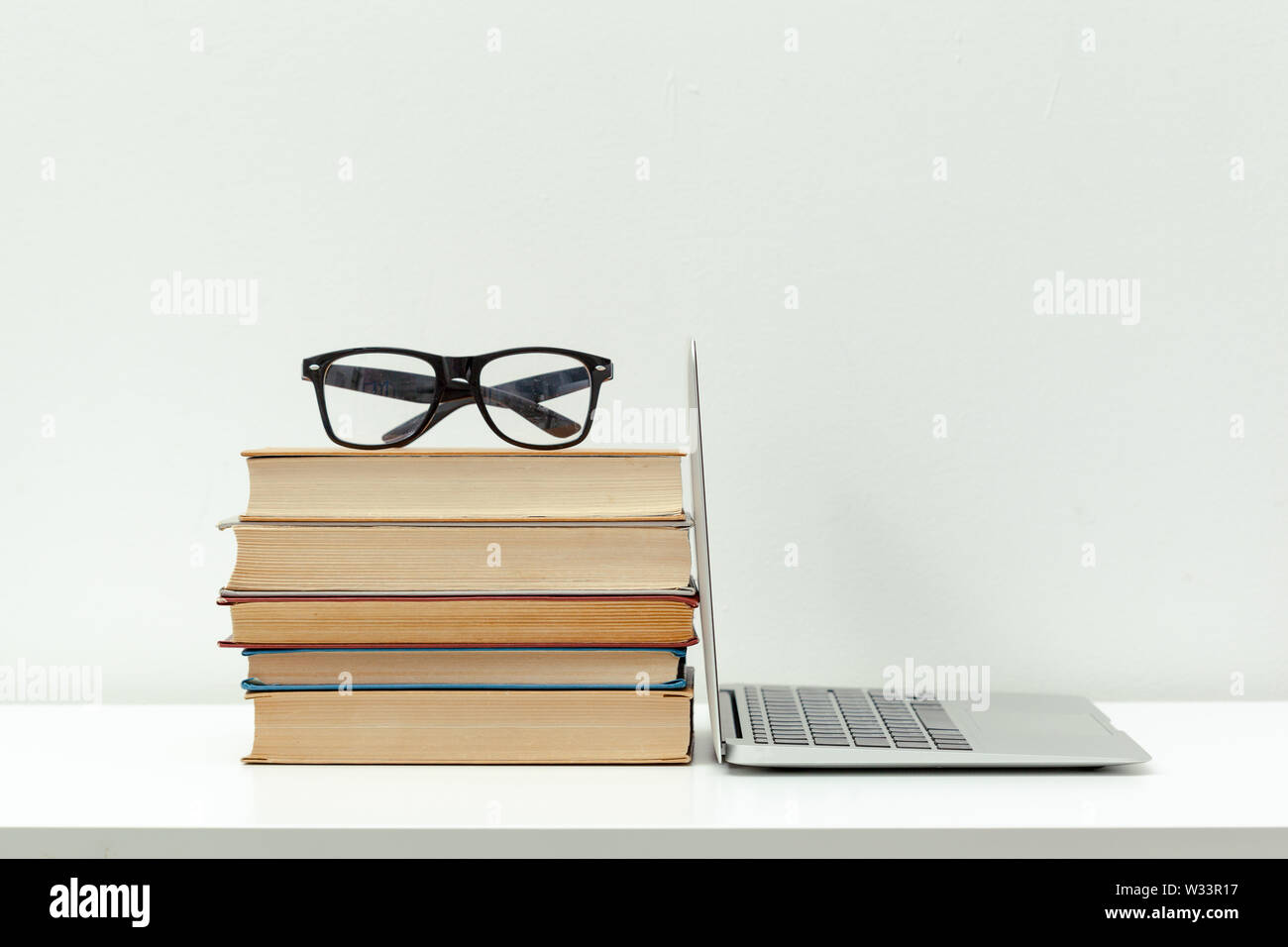 Working desk.Open laptop, books and other office supply Stock Photo - Alamy