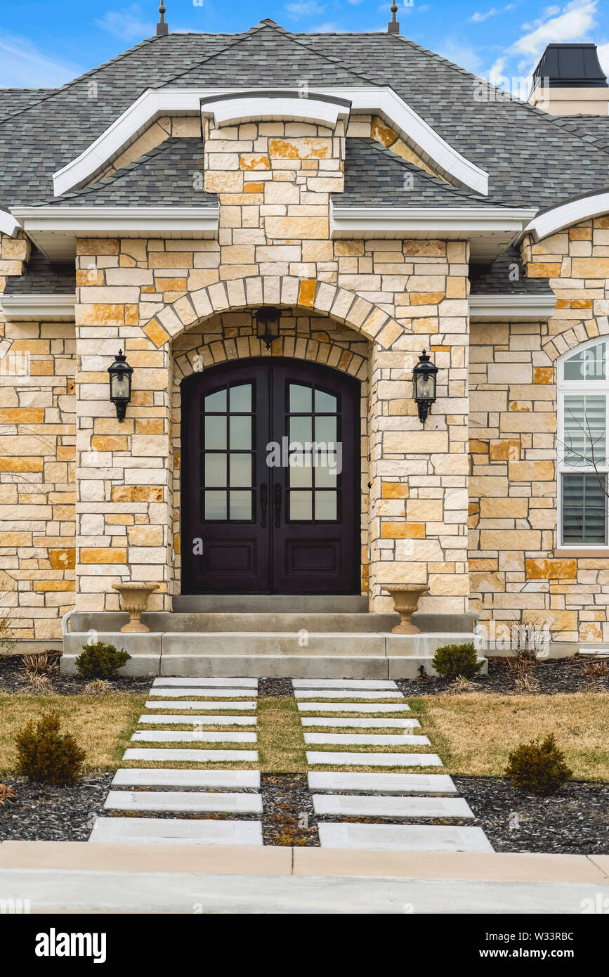 Home with footpath and stairs leading to the arched glass paned double ...
