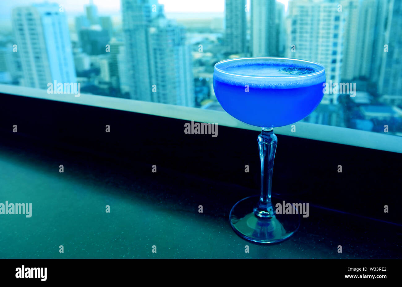 Pop art style royal blue colored cocktail with light blue skyscrapers ...