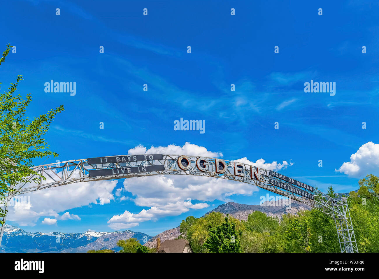Welcome arch at the city of Ogden Utah against vivid blue sky and puffy ...