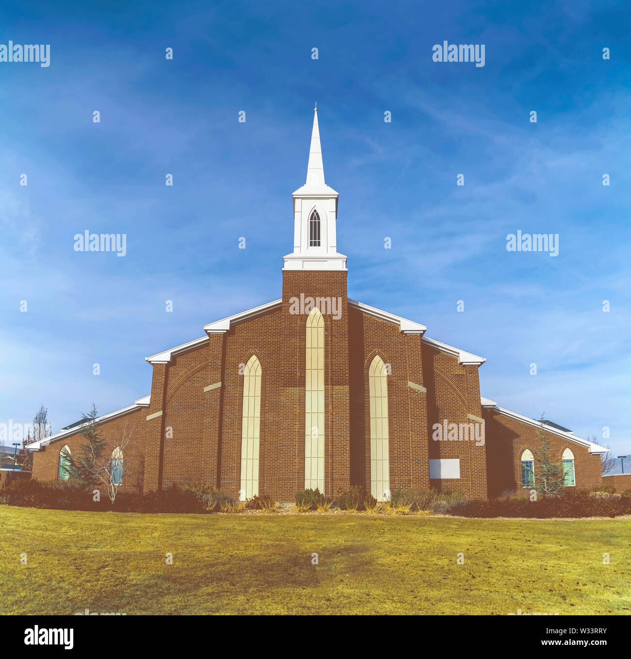 Exterior view of a magnificent church with cloudy blue sky background ...