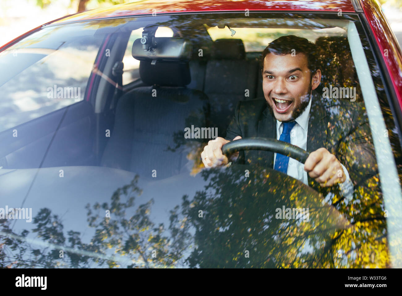 Shocked driver in the car, frightened man driving Stock Photo - Alamy