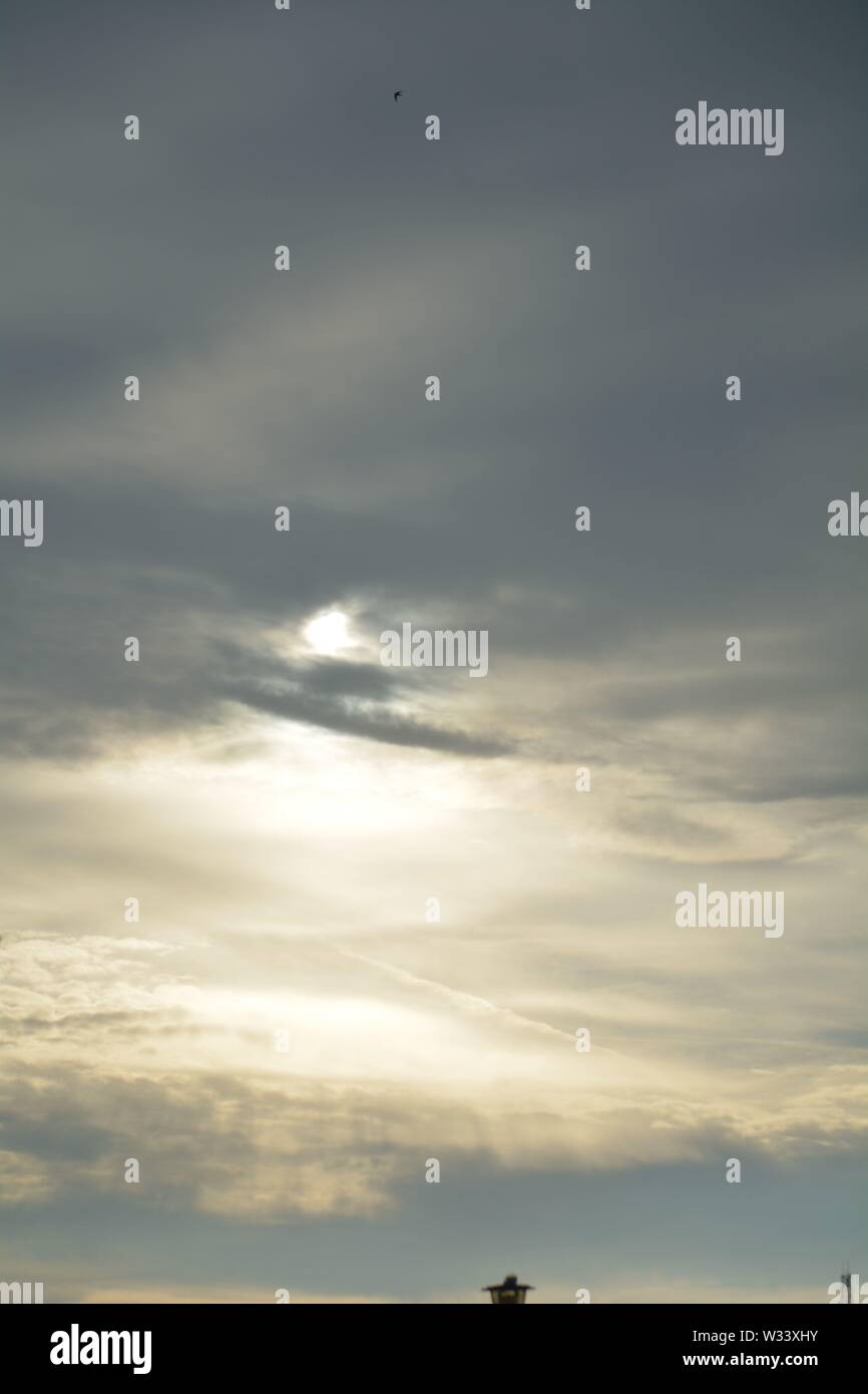 Patterns of clouds in the spring sky with the sun backlighting Stock ...
