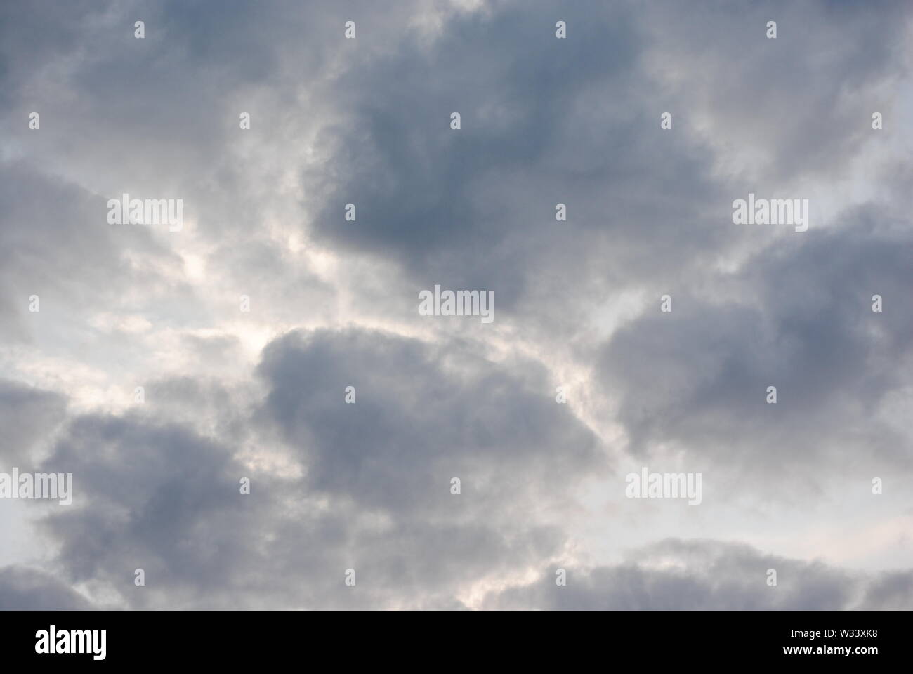 Patterns of clouds in the spring sky with the sun backlighting Stock ...