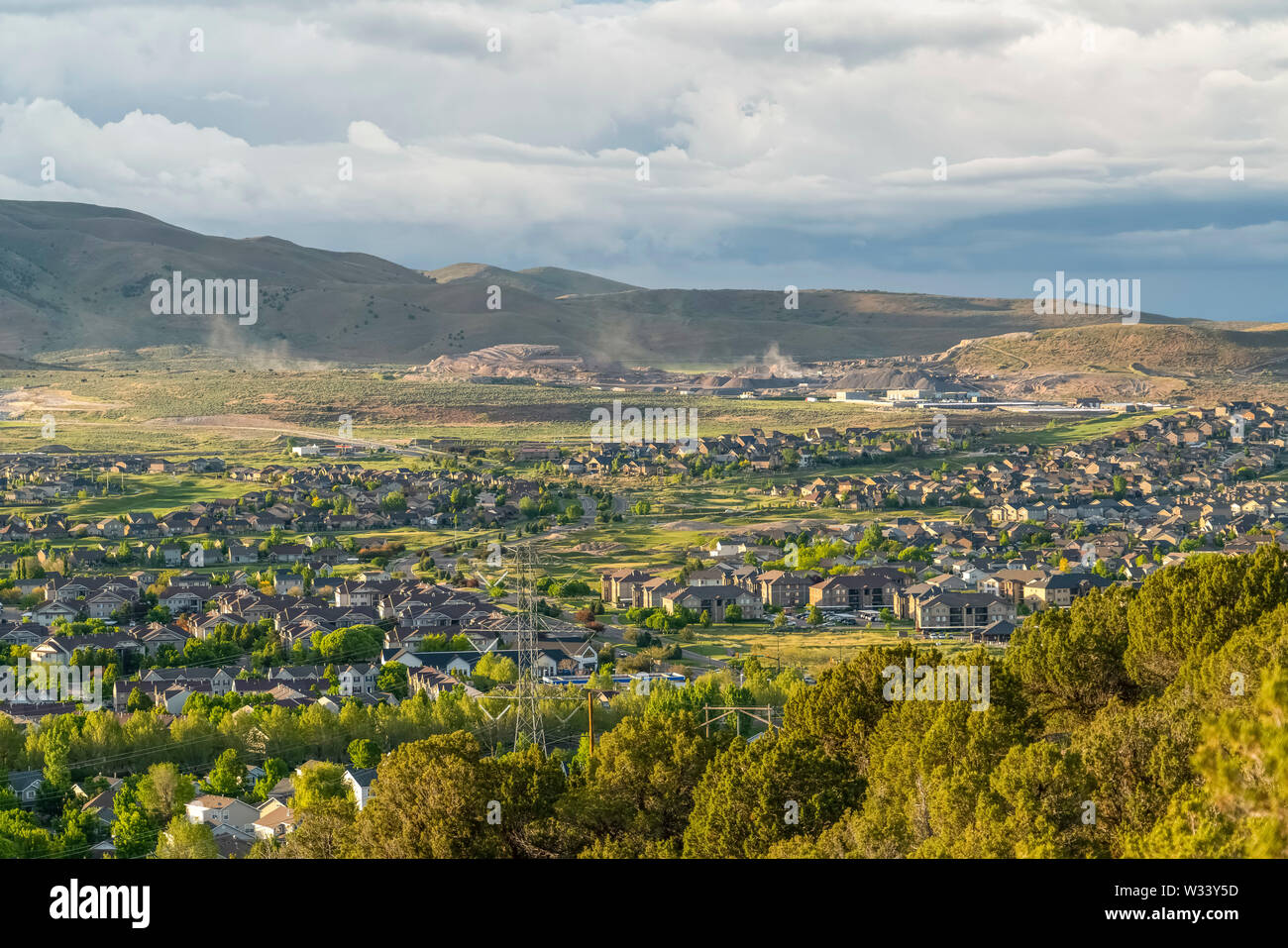 Residential area on a valley with view of distant mountain and cloudy ...