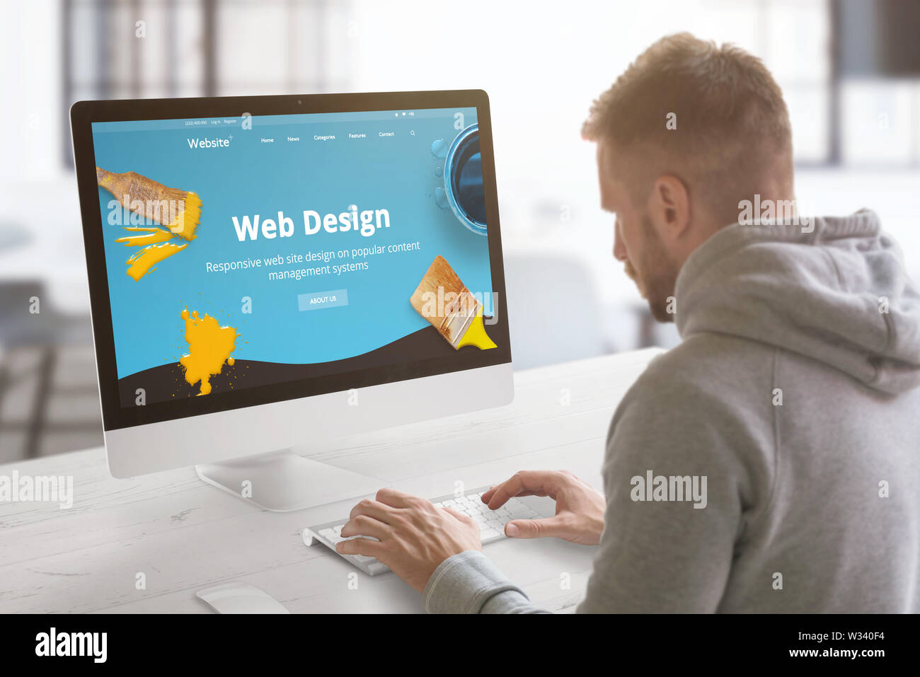 Guy work on modern web site on computer in graphic, web design studio ...