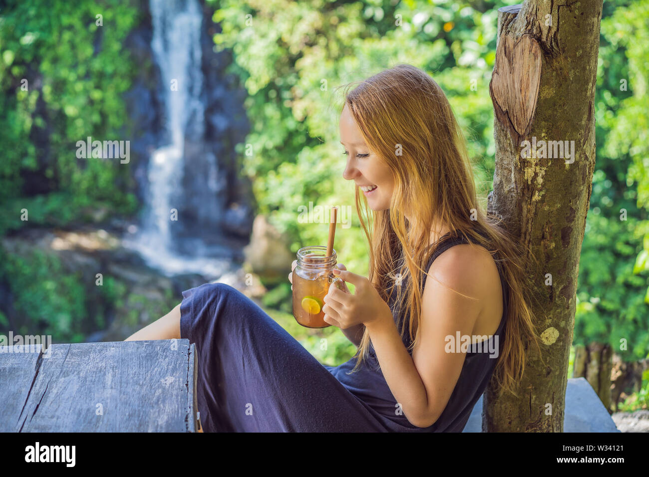 Closeup portrait image of a beautiful woman drinking ice tea with ...
