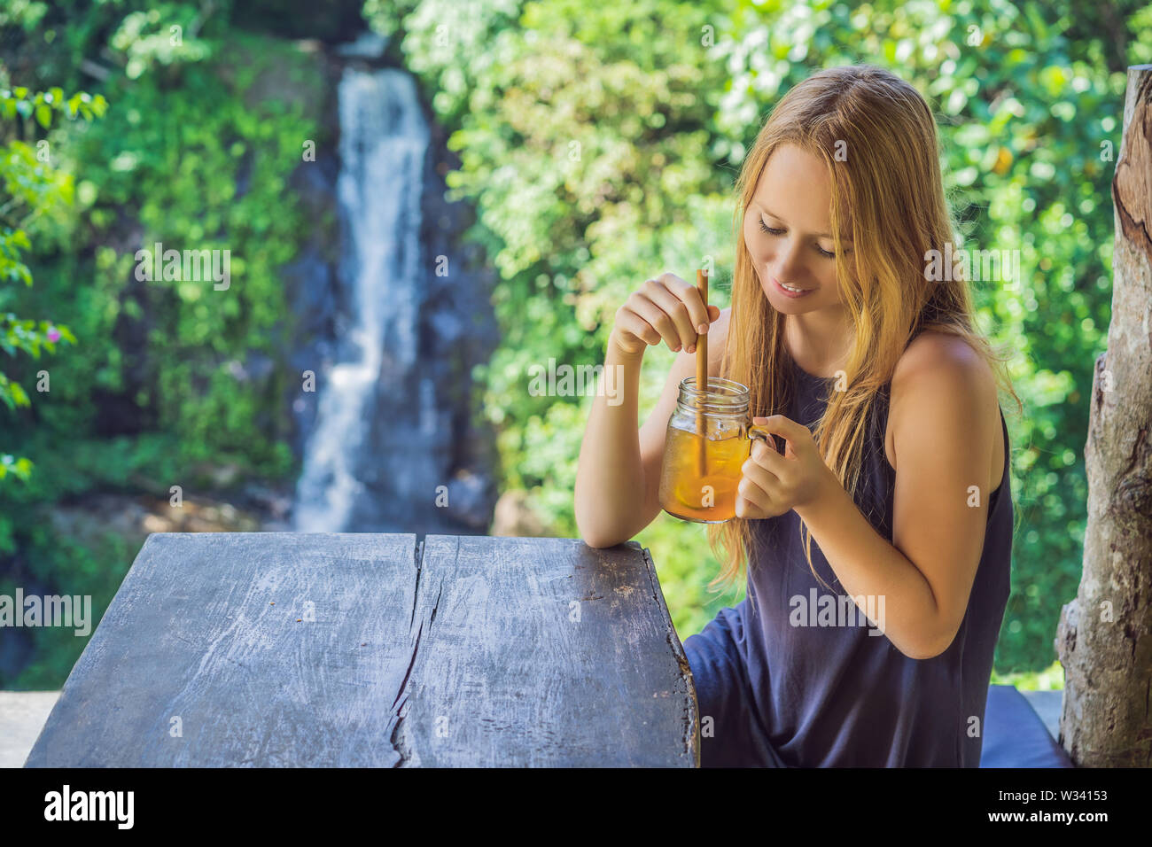 Closeup portrait image of a beautiful woman drinking ice tea with ...
