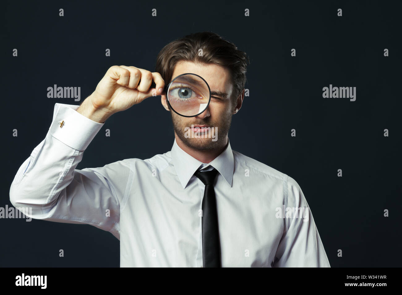 business man holding magnifying glass Stock Photo - Alamy