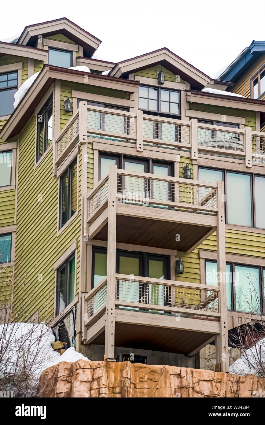 Facade of a residential building against cloudy sky on a snowy winter ...