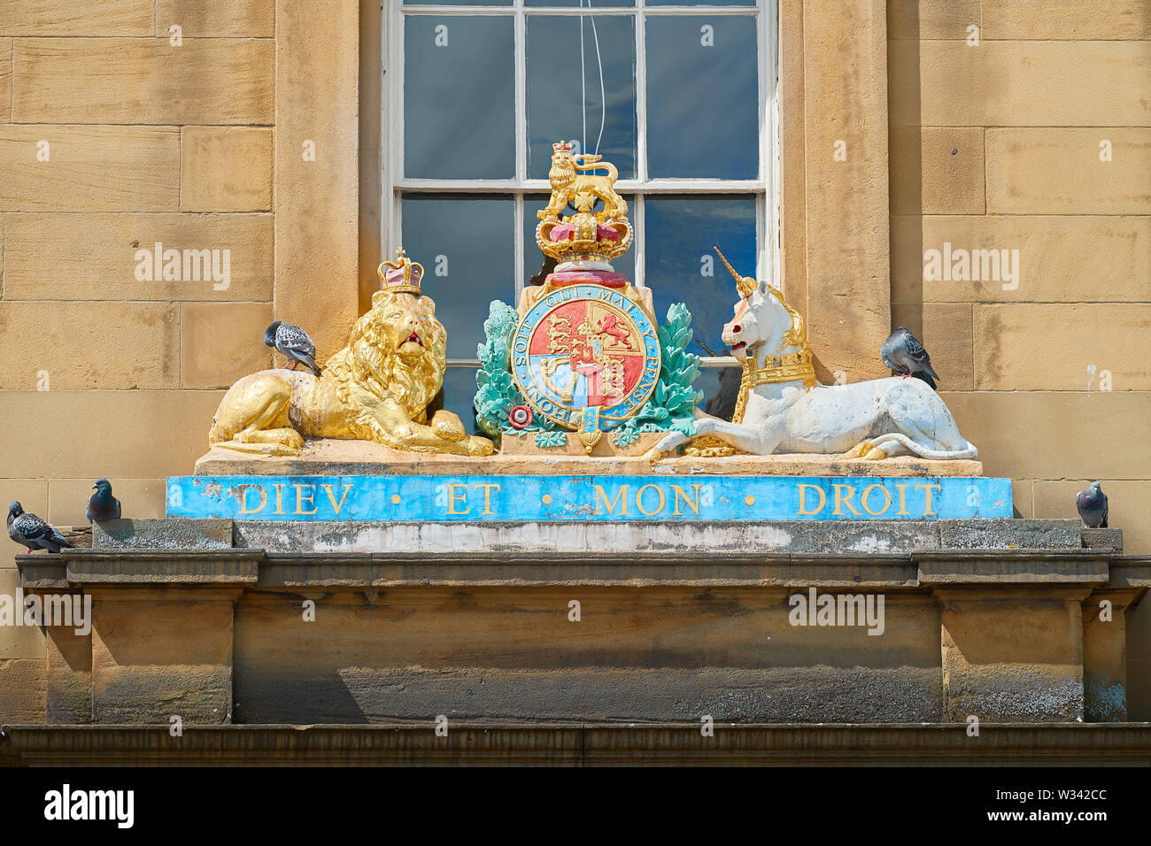 Royal badge and motto over the customs house door on the quayside by ...