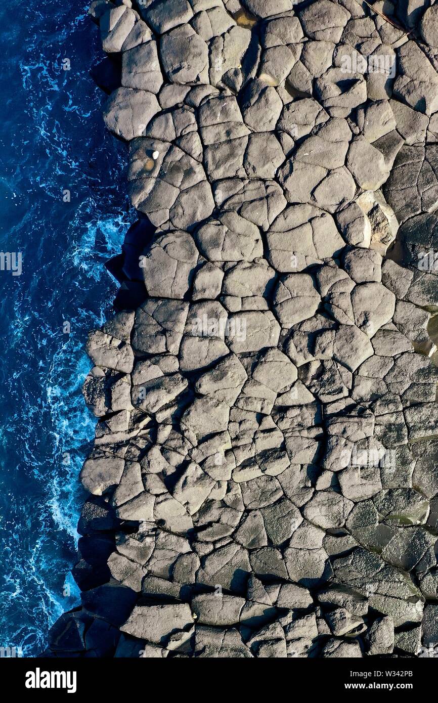 Volcanic rock from above ocean waves Stock Photo - Alamy