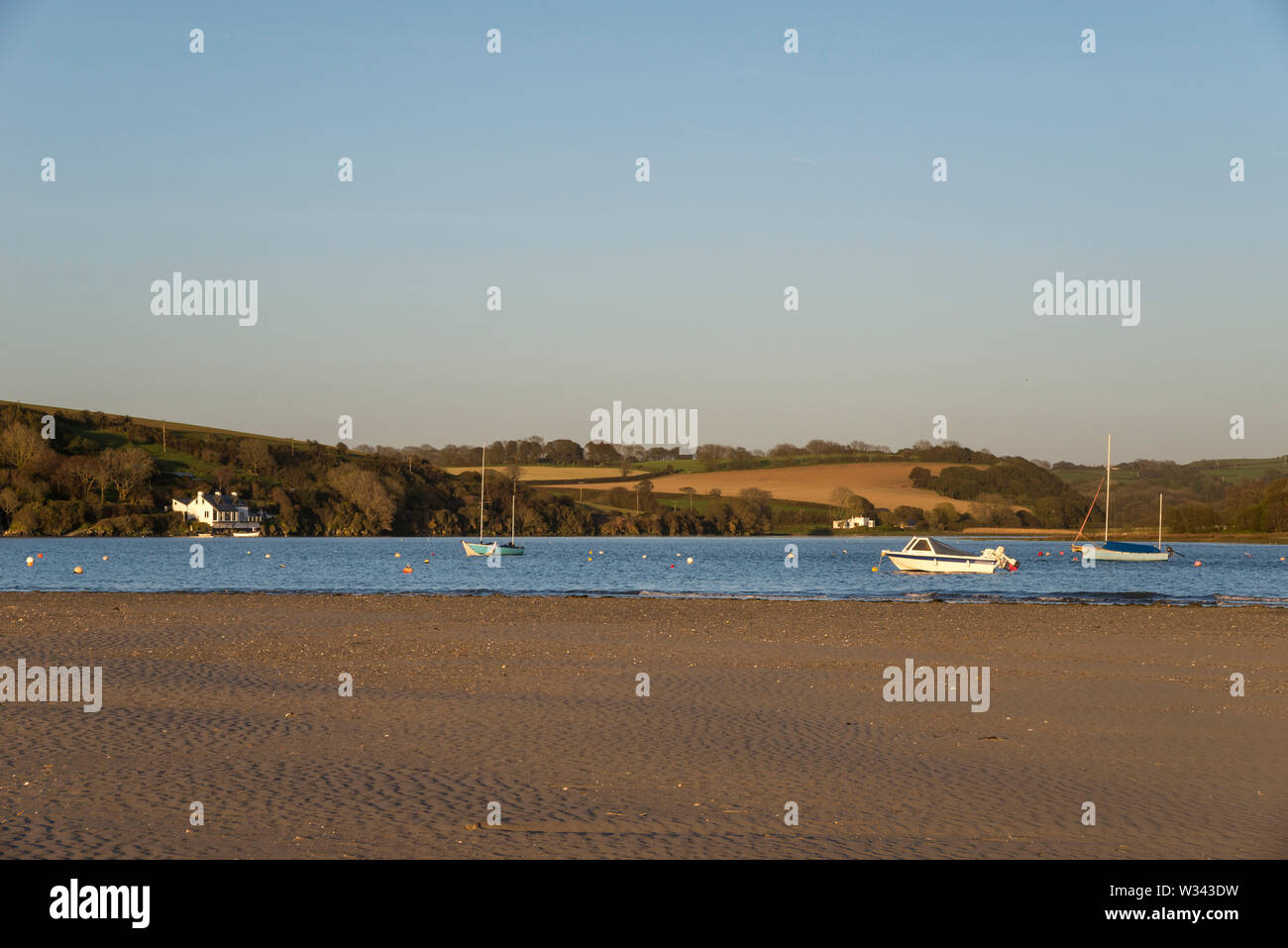 The river Nevern at Newport, Pembrokeshire, Wales. Boats in the estuary ...