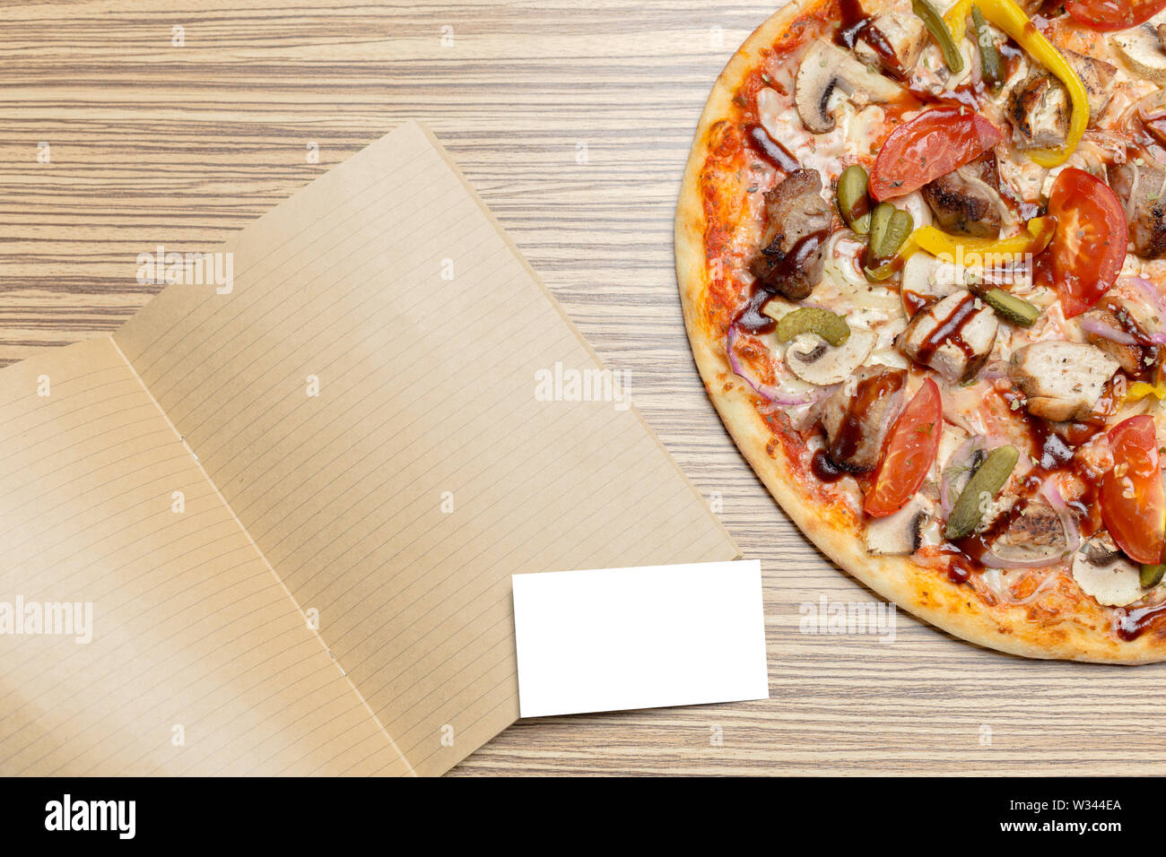 Pizza with blank paper with copy space Stock Photo - Alamy
