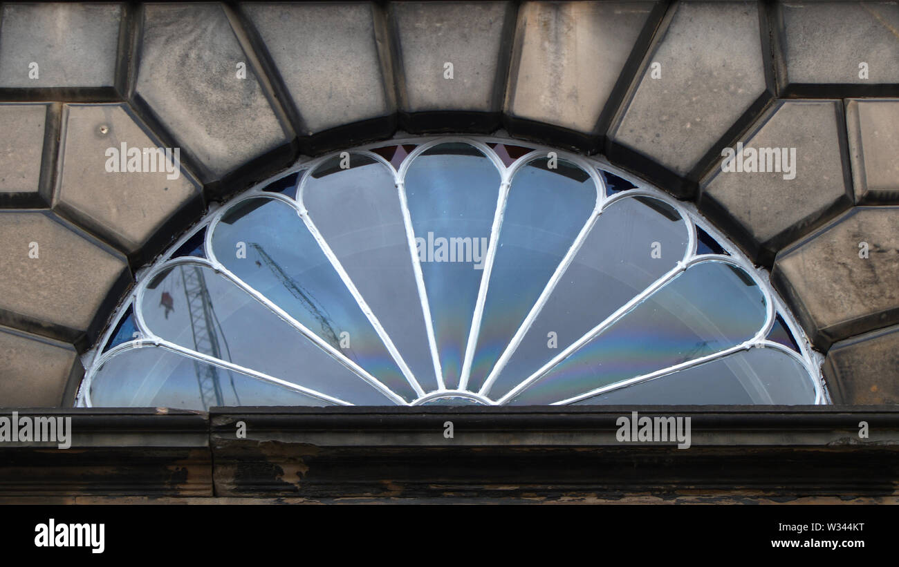 A semi circle window above a doorway in a building in Edinburgh ...