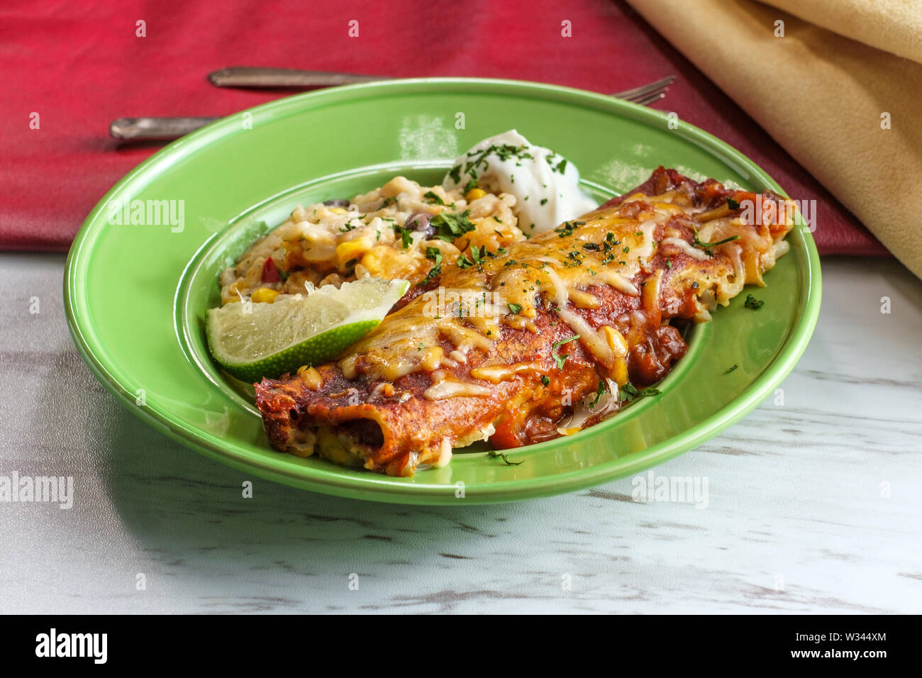 Authentic Mexican chimichanga enchilada with sour cream and rice ...