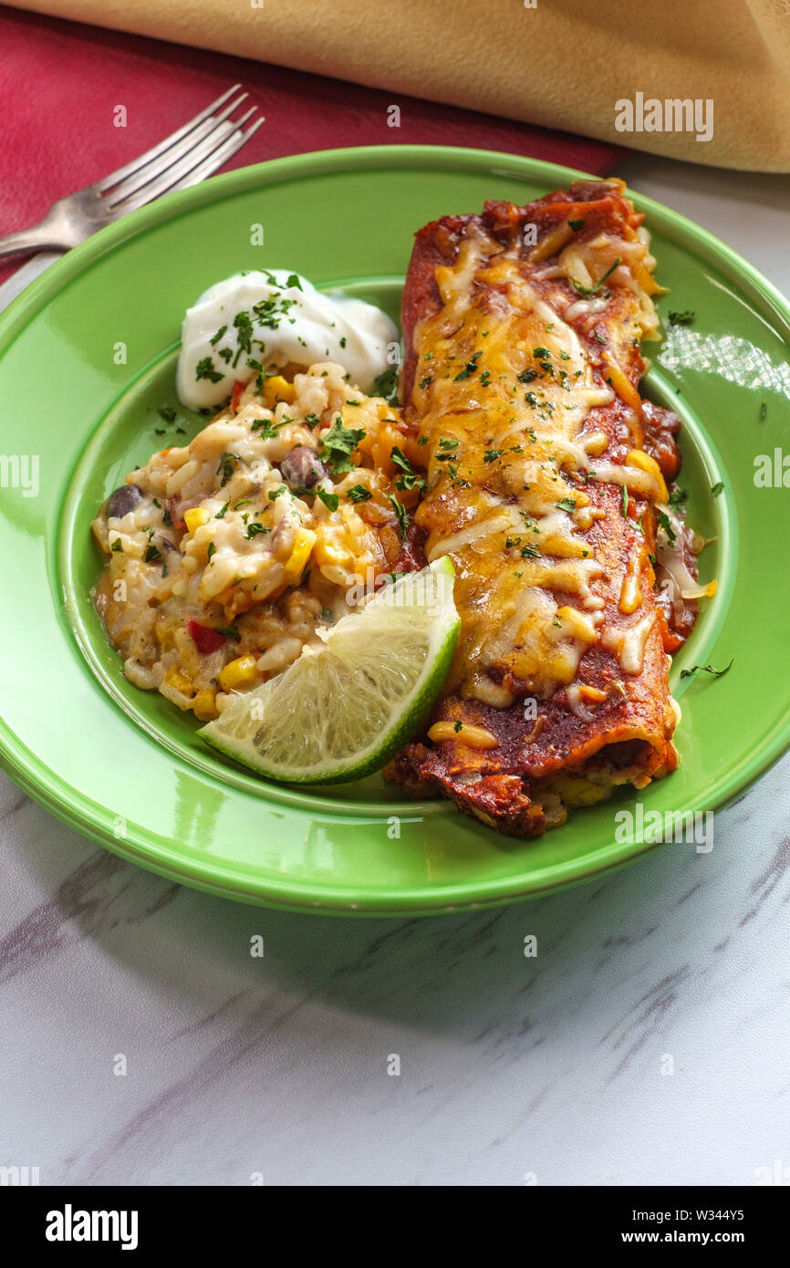 Authentic Mexican chimichanga enchilada with sour cream and rice ...
