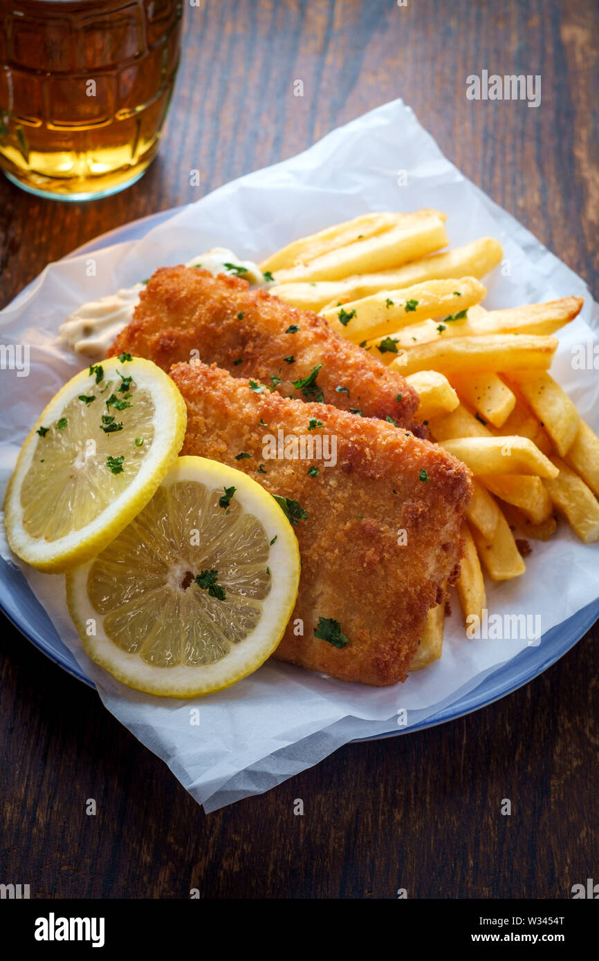 Authentic traditional British cuisine fish and chips served with an ice ...