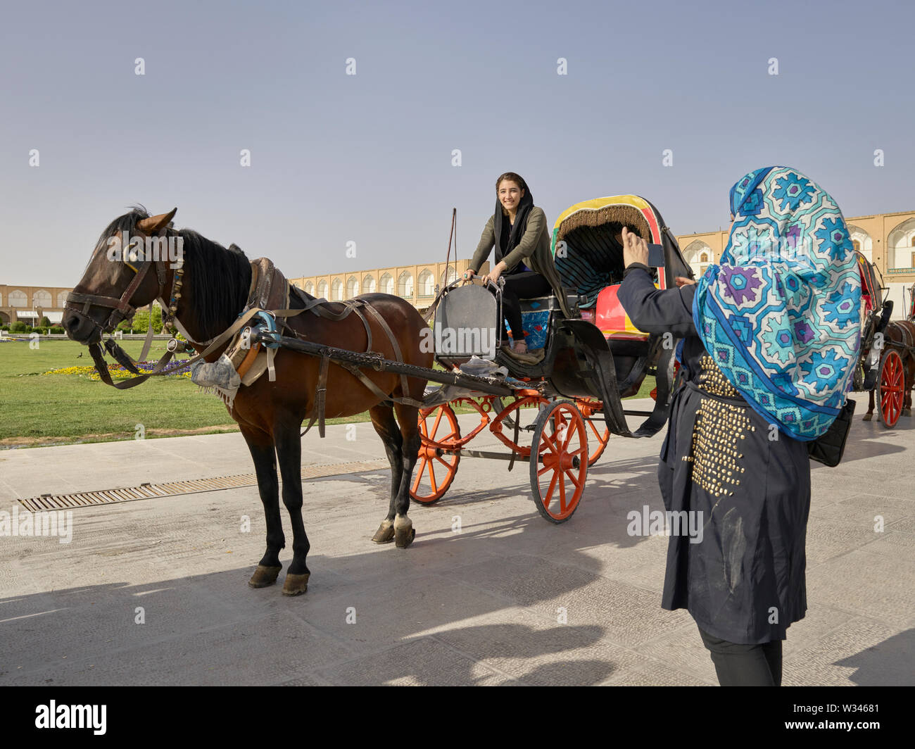 22.04.2017, Iran, Isfahan: Horse-drawn carriages with visitors on the ...