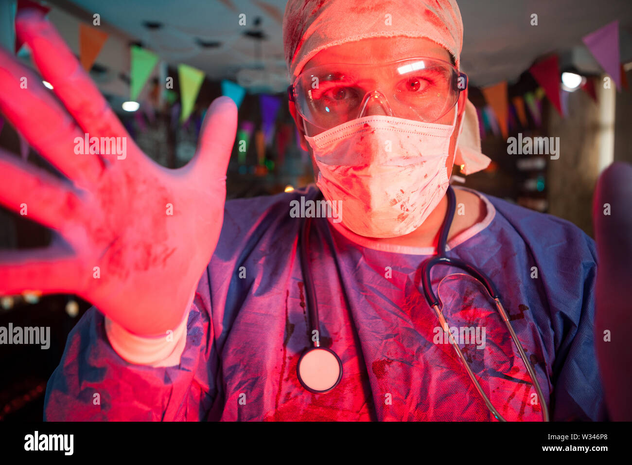 Close up of doctor with blood on his costume at halloween party ...