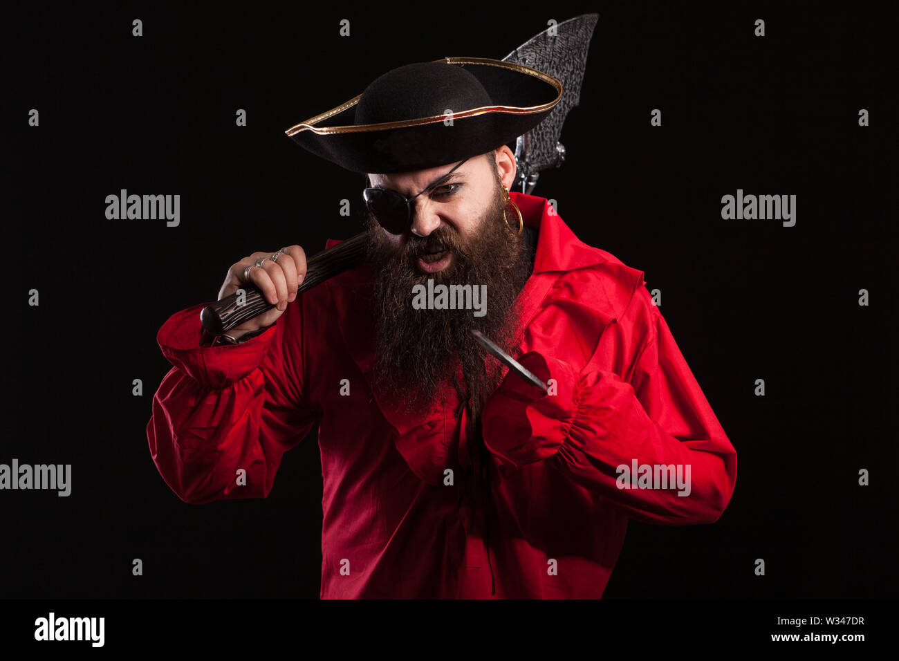 Portrait of a medieval bearded pirate on black background. Male pirate ...
