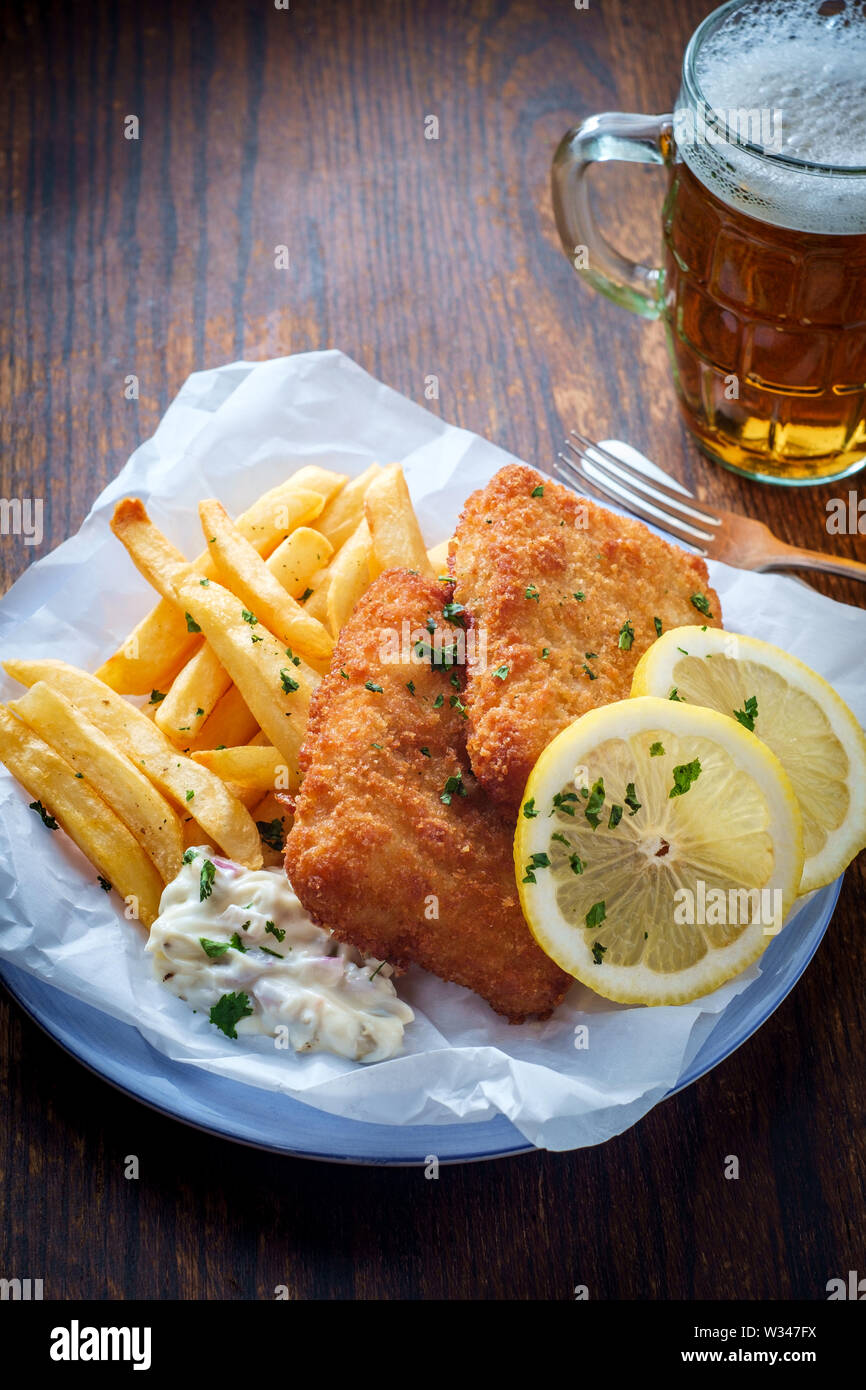 Authentic traditional British cuisine fish and chips served with an ice ...