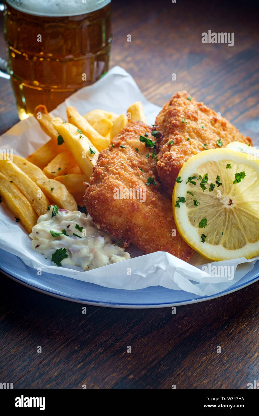 Authentic traditional British cuisine fish and chips served with an ice ...
